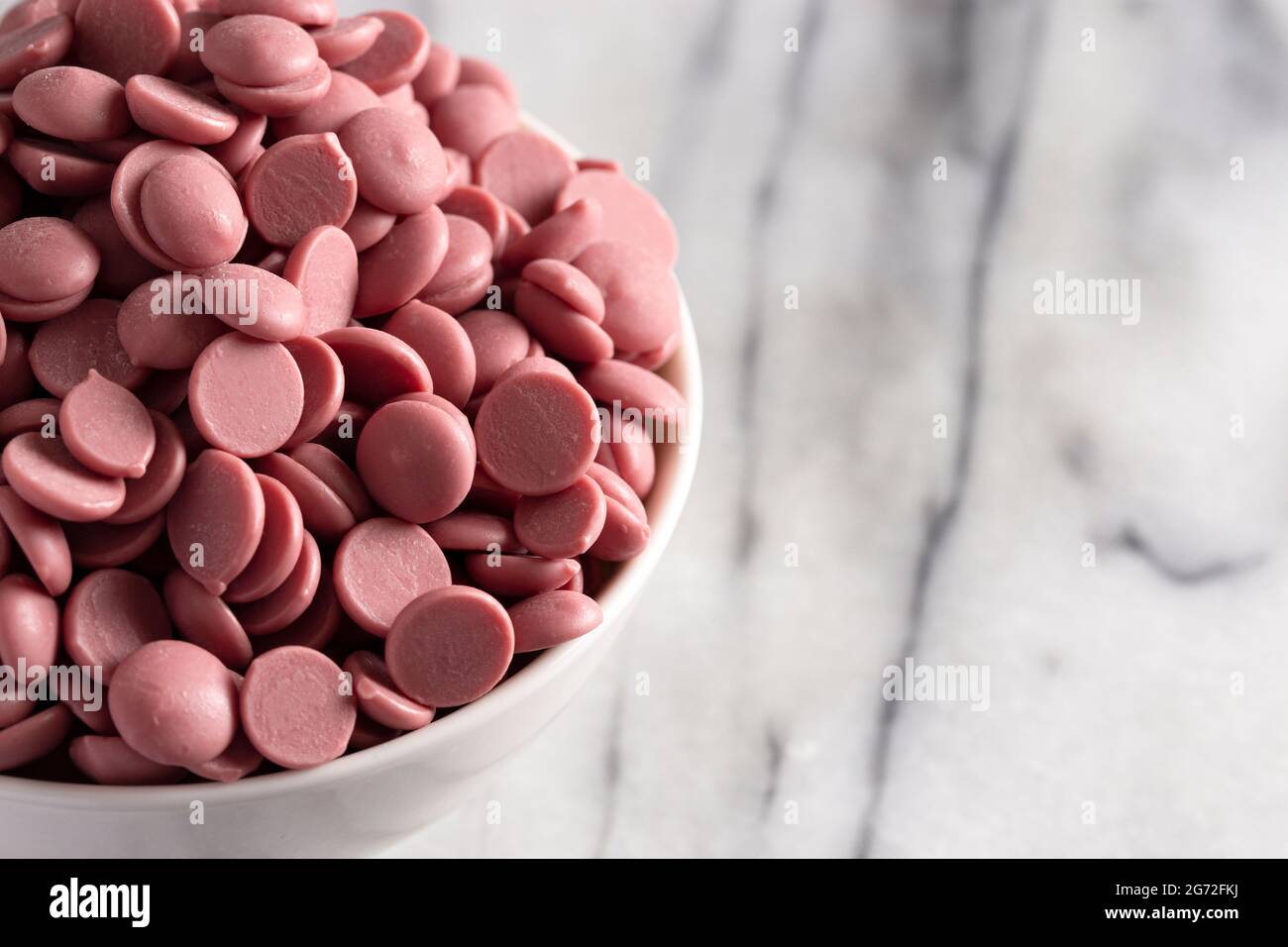 A Bowl of Authentic Ruby Chocolate Drops on a Marble Counter Stock ...
