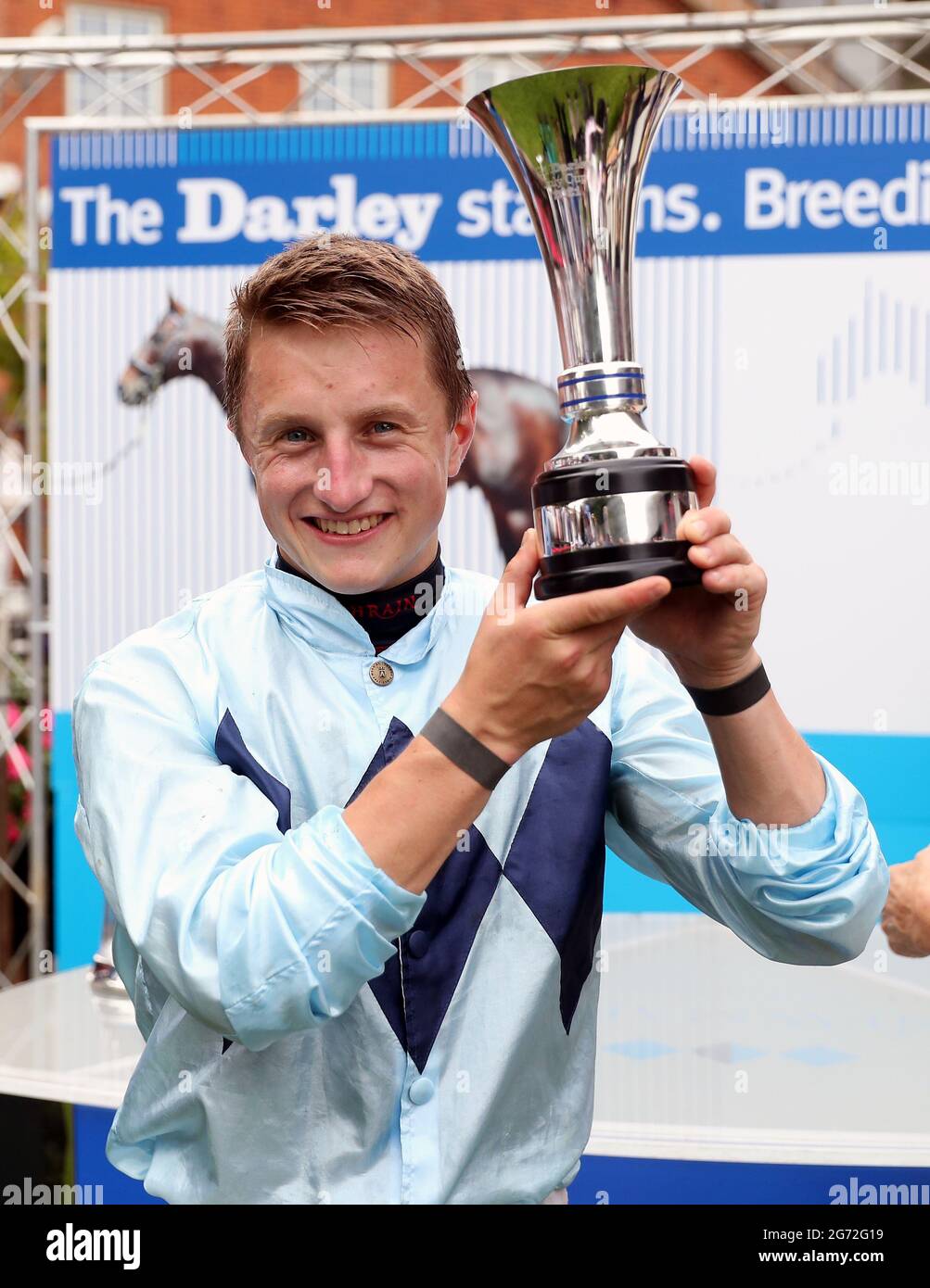 Jockey Tom Marquand with the trophy after winning the Darley July Cup ...