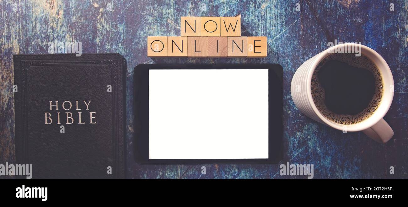 Now Online Written in Block Letters on a Wooden Table with a Bible and ...
