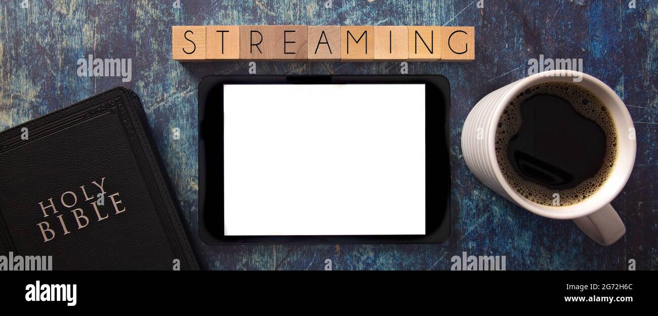 Streaming Written in Block Letters on a Wooden Table with a Bible and ...