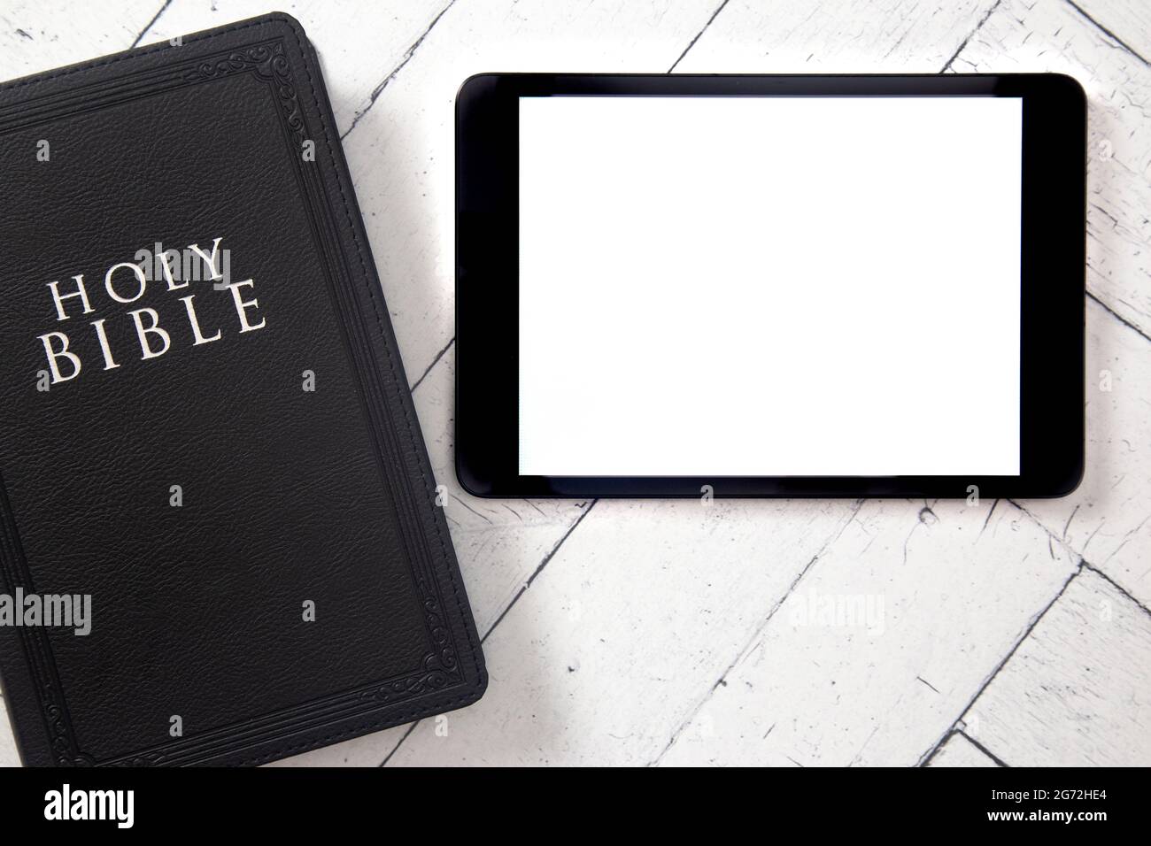 A Bible and Blank Tablet on a White Wooden Surface Stock Photo - Alamy