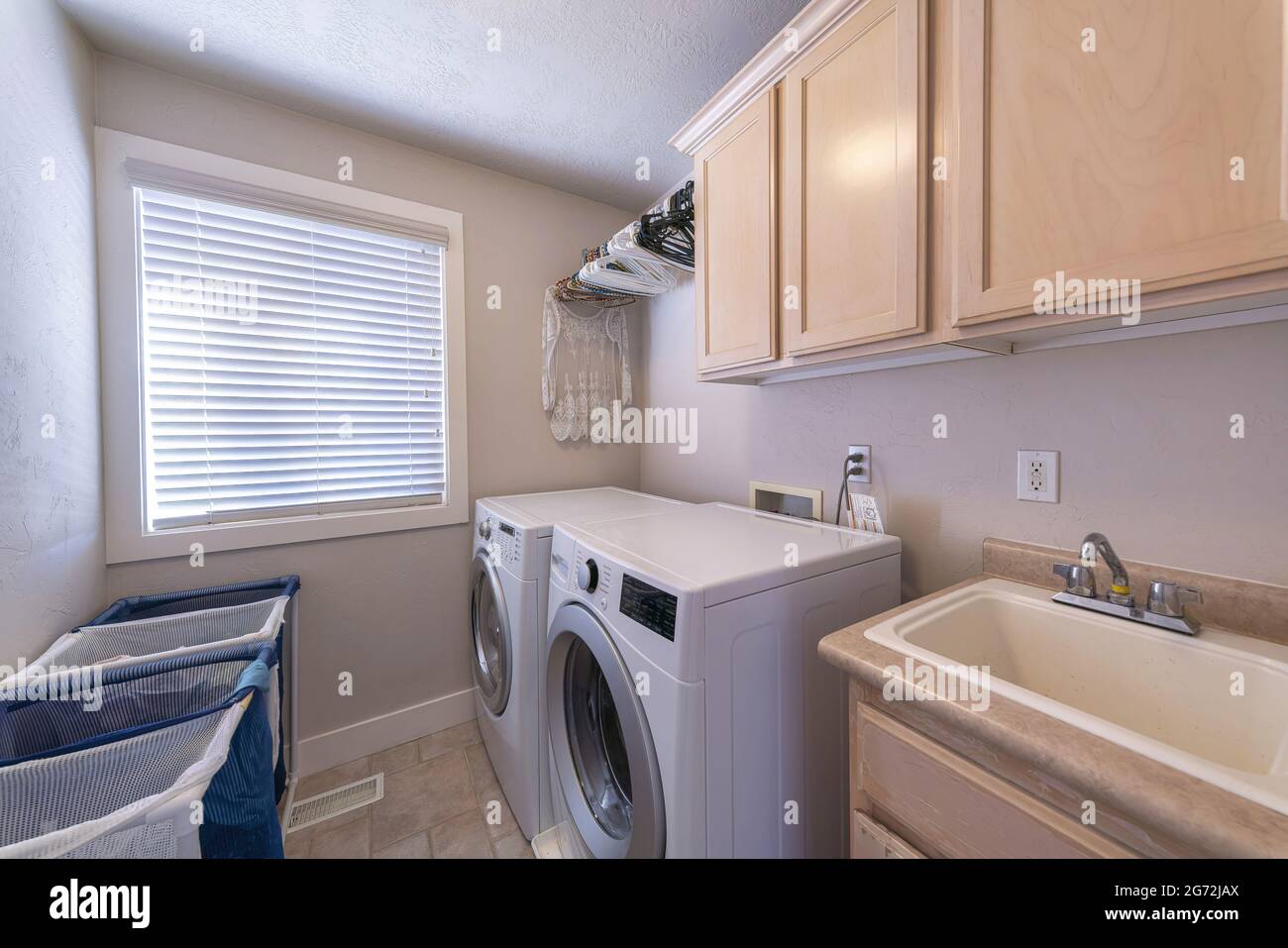 Bathroom of a modern apartment with white furniture Stock Photo - Alamy