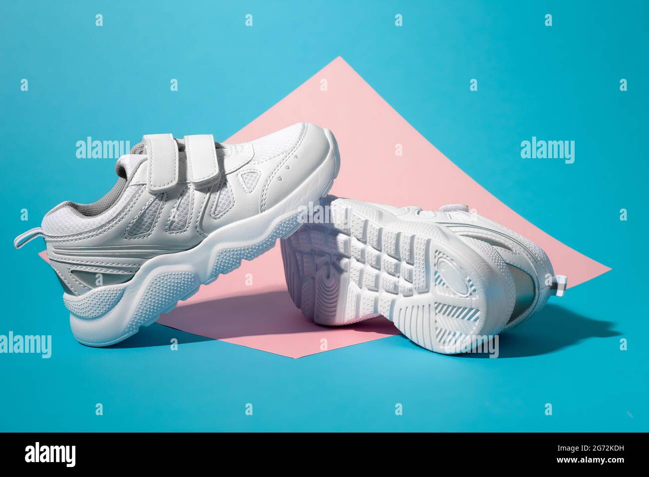macro side view one white children's running shoe stands on the sole of ...