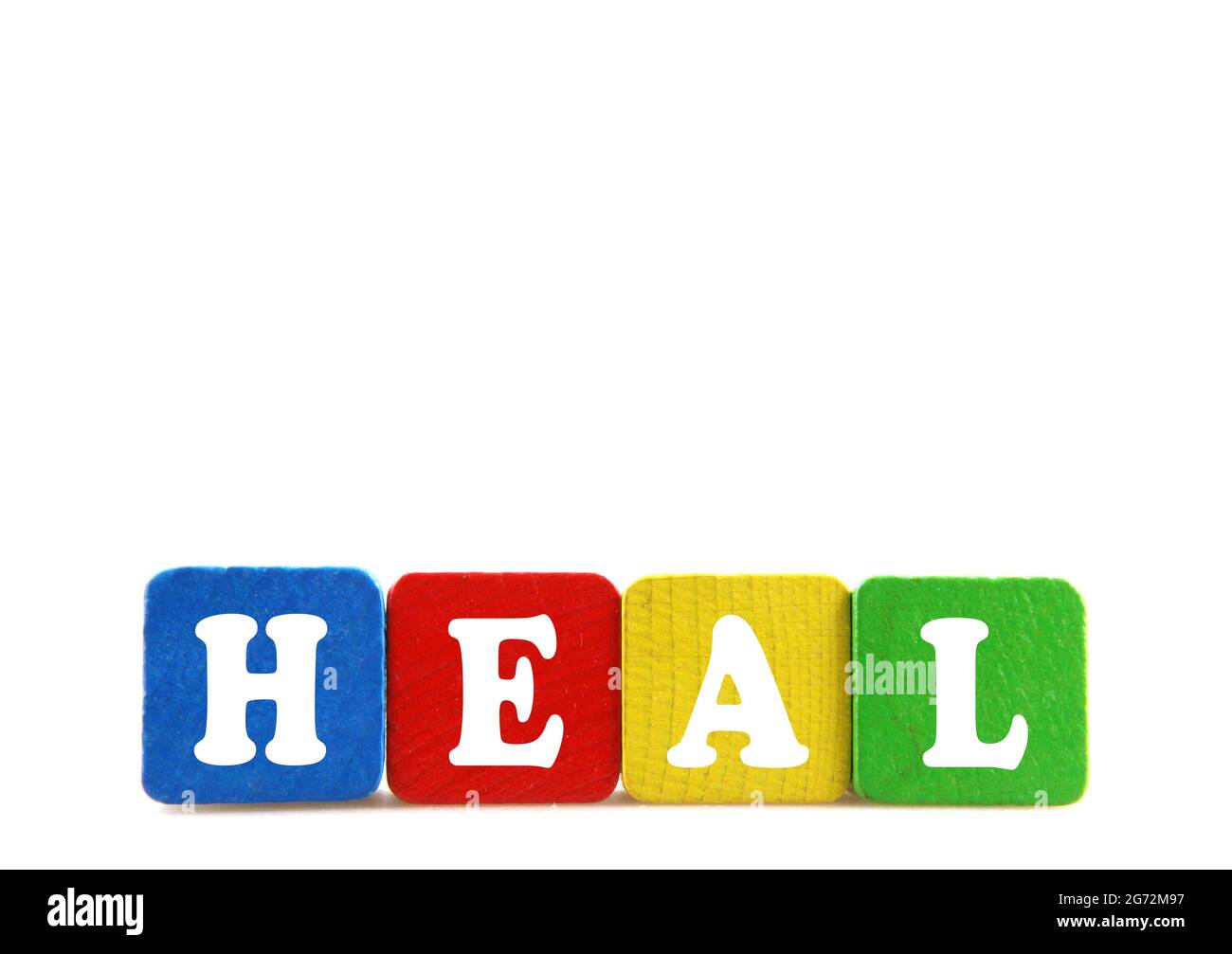 Word "Heal" arranged of wooden colorful cubes isolated on white ...