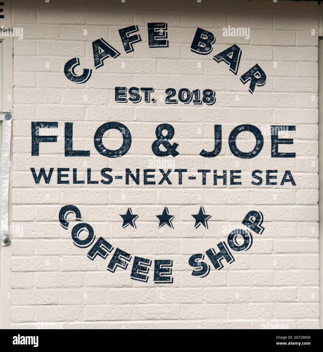 Small cafe bar sign on a wall Stock Photo - Alamy