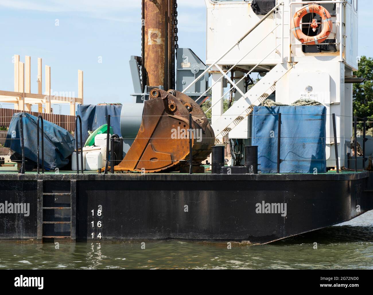 Rusty excavator bucket on a barge Stock Photo - Alamy