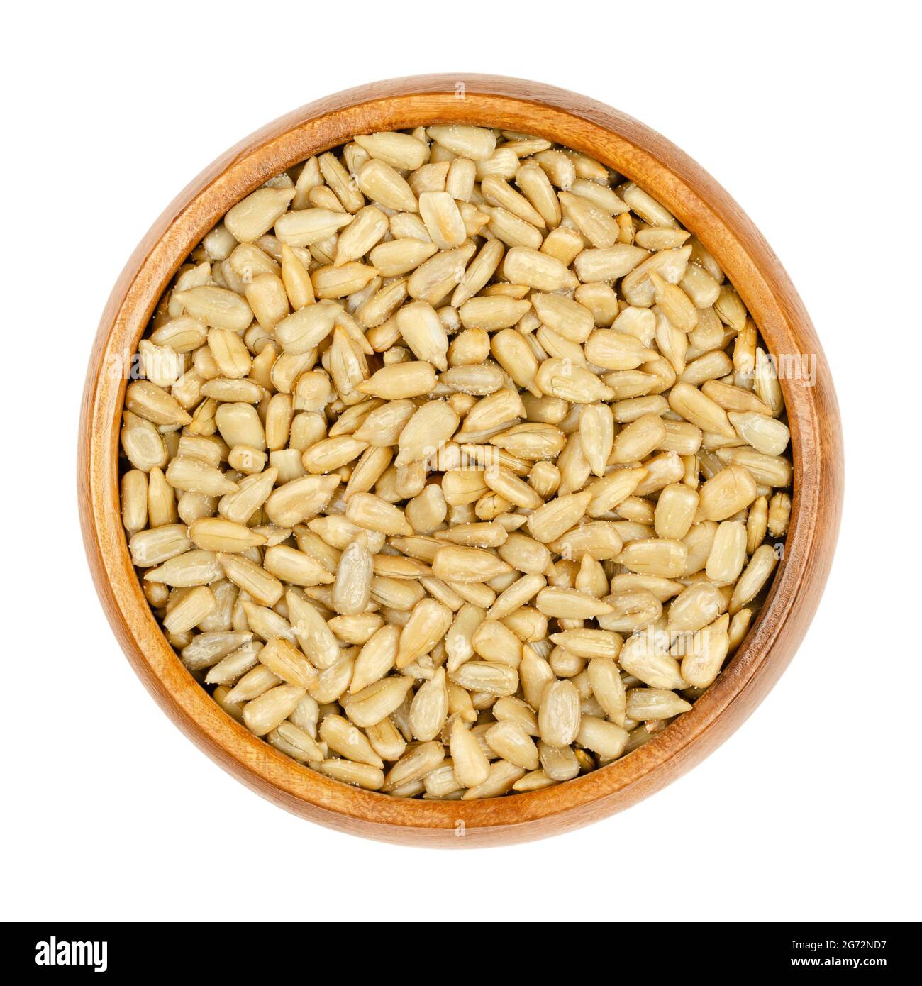 Hulled sunflower seeds, roasted and salted, in a wooden bowl. Crunchy ...