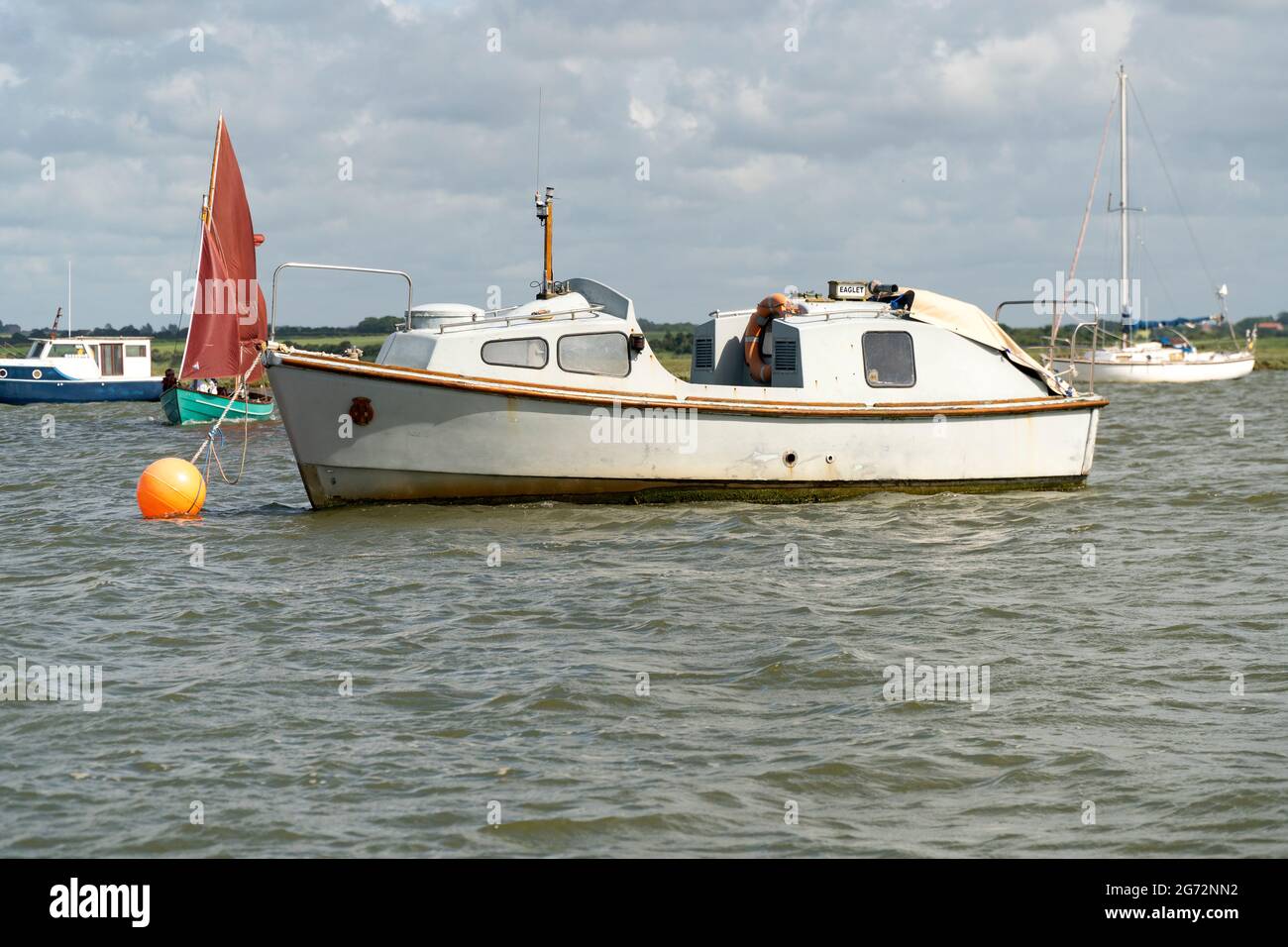 Small cabin cruiser anchored at sea Stock Photo - Alamy