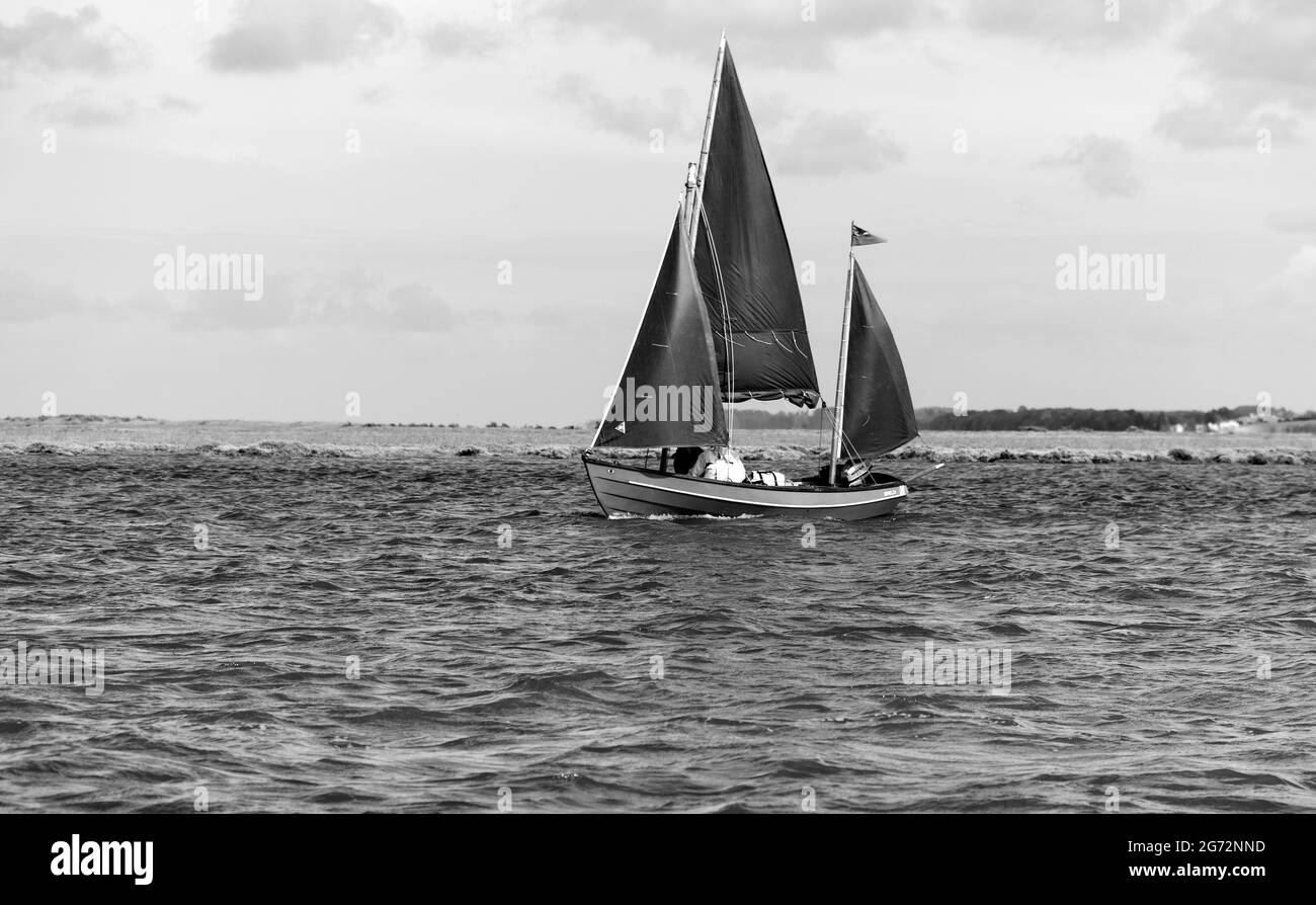 Small sailing boat under way Stock Photo - Alamy