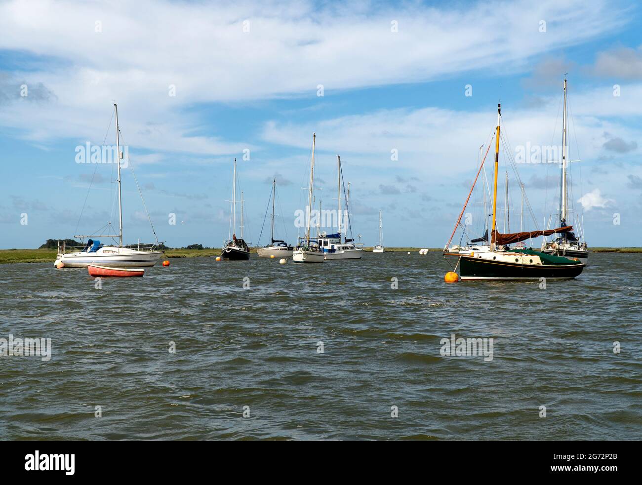Small boats moored together at high tide Stock Photo - Alamy