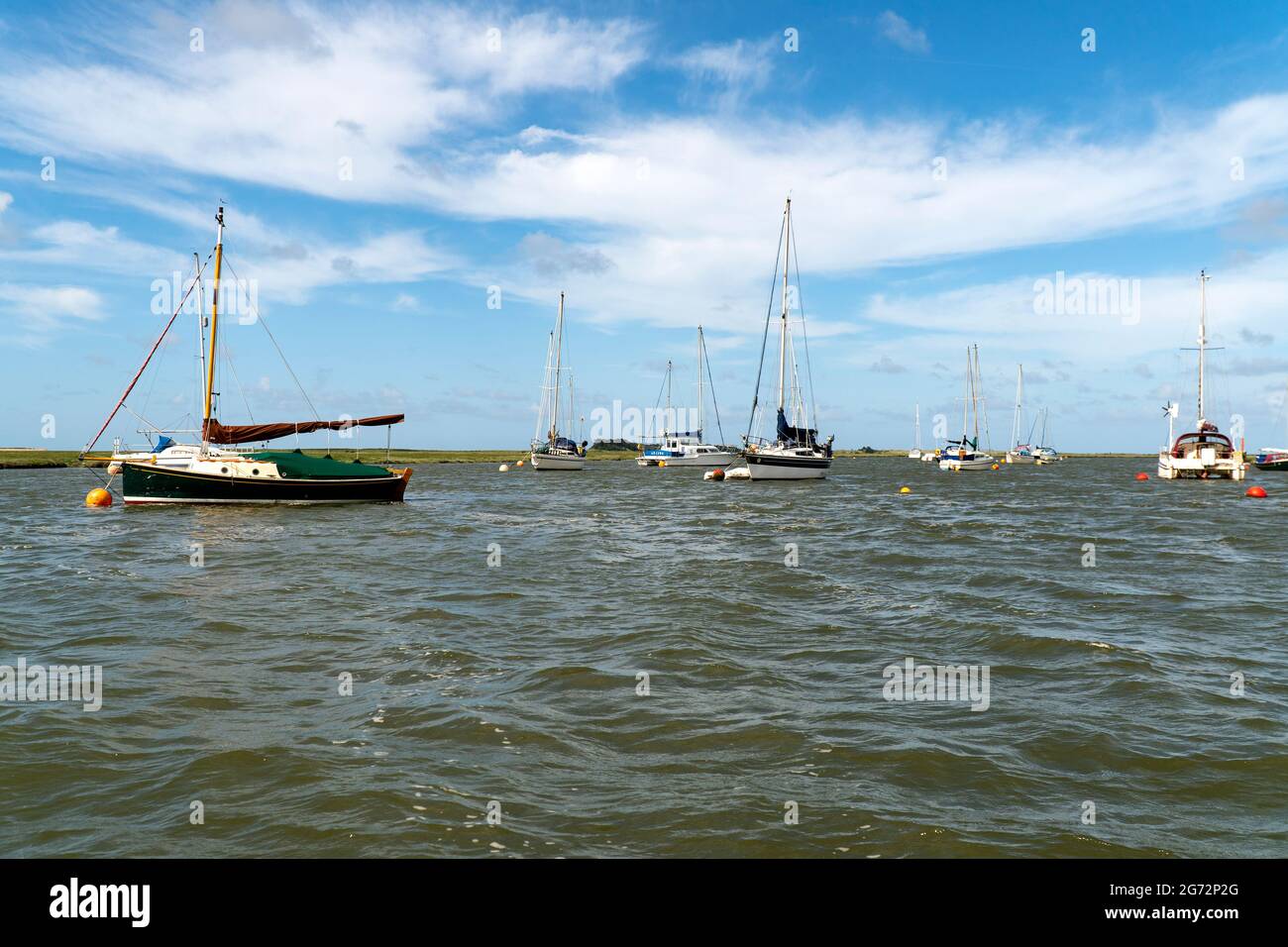 Small boats moored together at high tide Stock Photo - Alamy