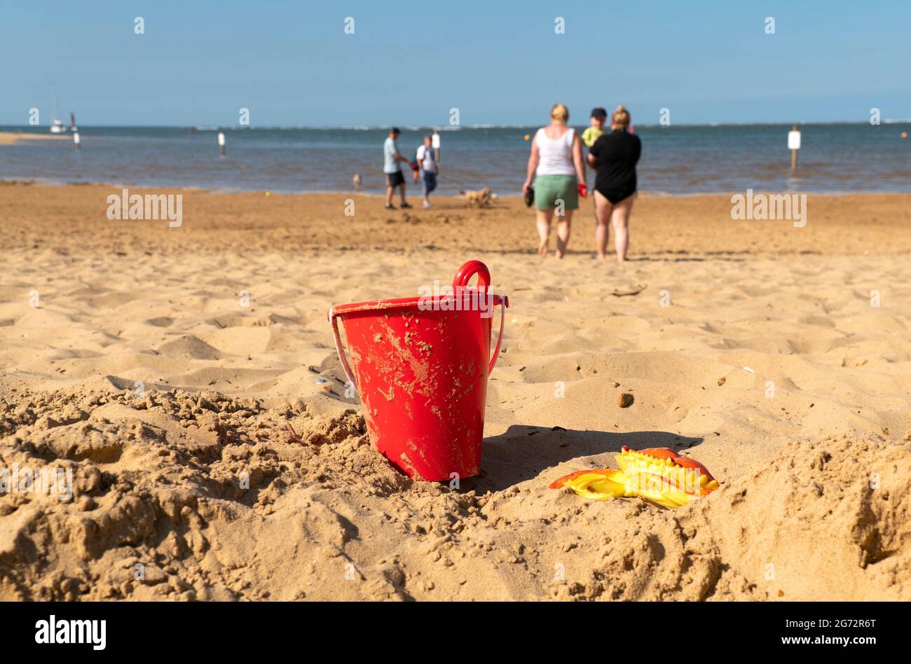 Red plastic bucket on a beach Stock Photo - Alamy