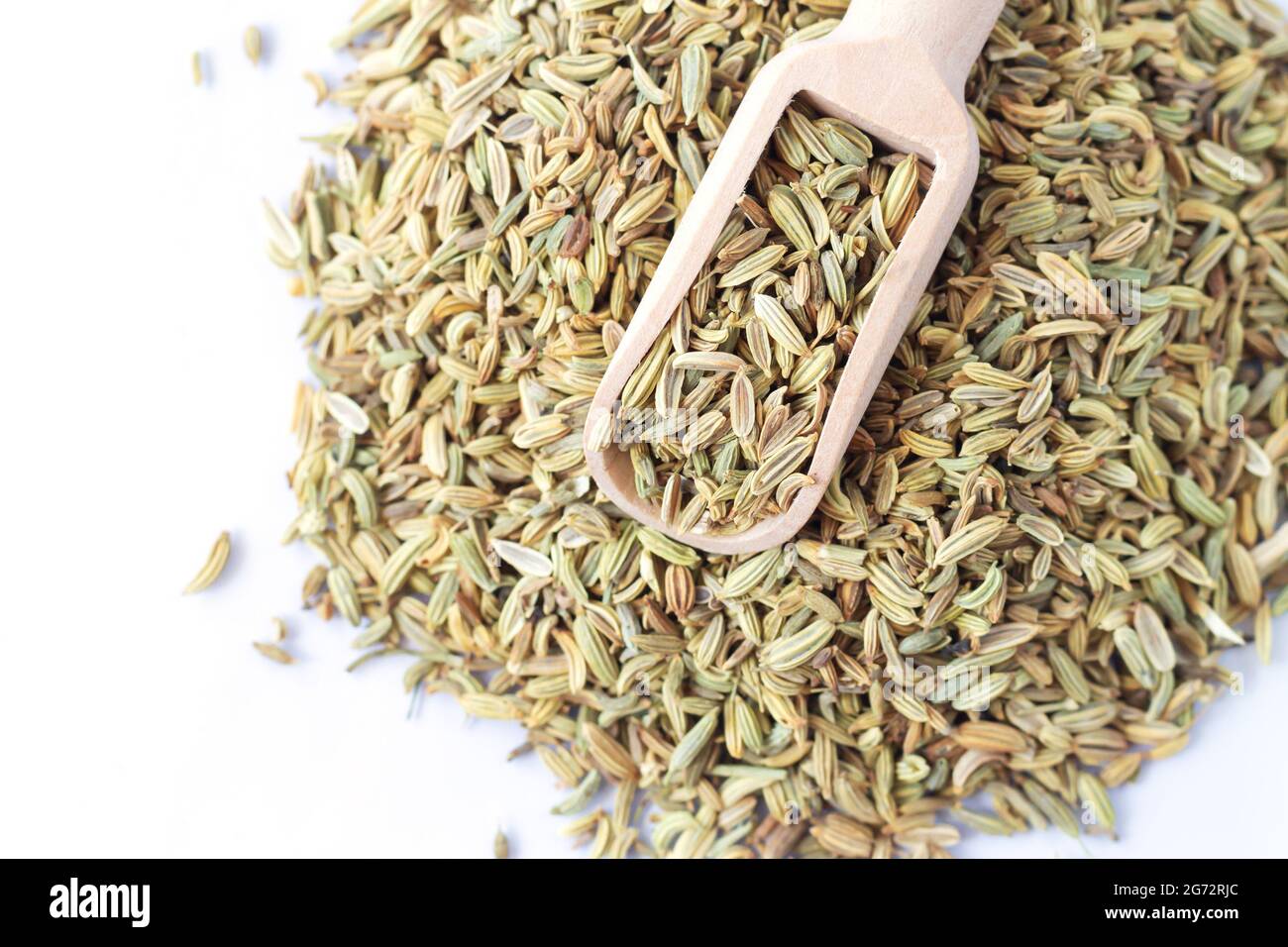 Pile of dried fennel seeds with wooden scoop isolated on white ...