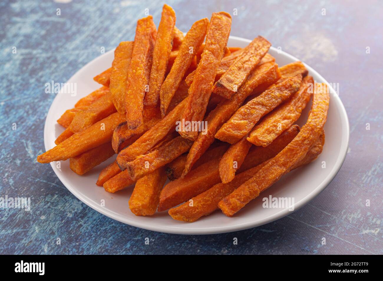 A Plate of Sweet Potatoe Fries on a Blue Wooden Table Stock Photo - Alamy