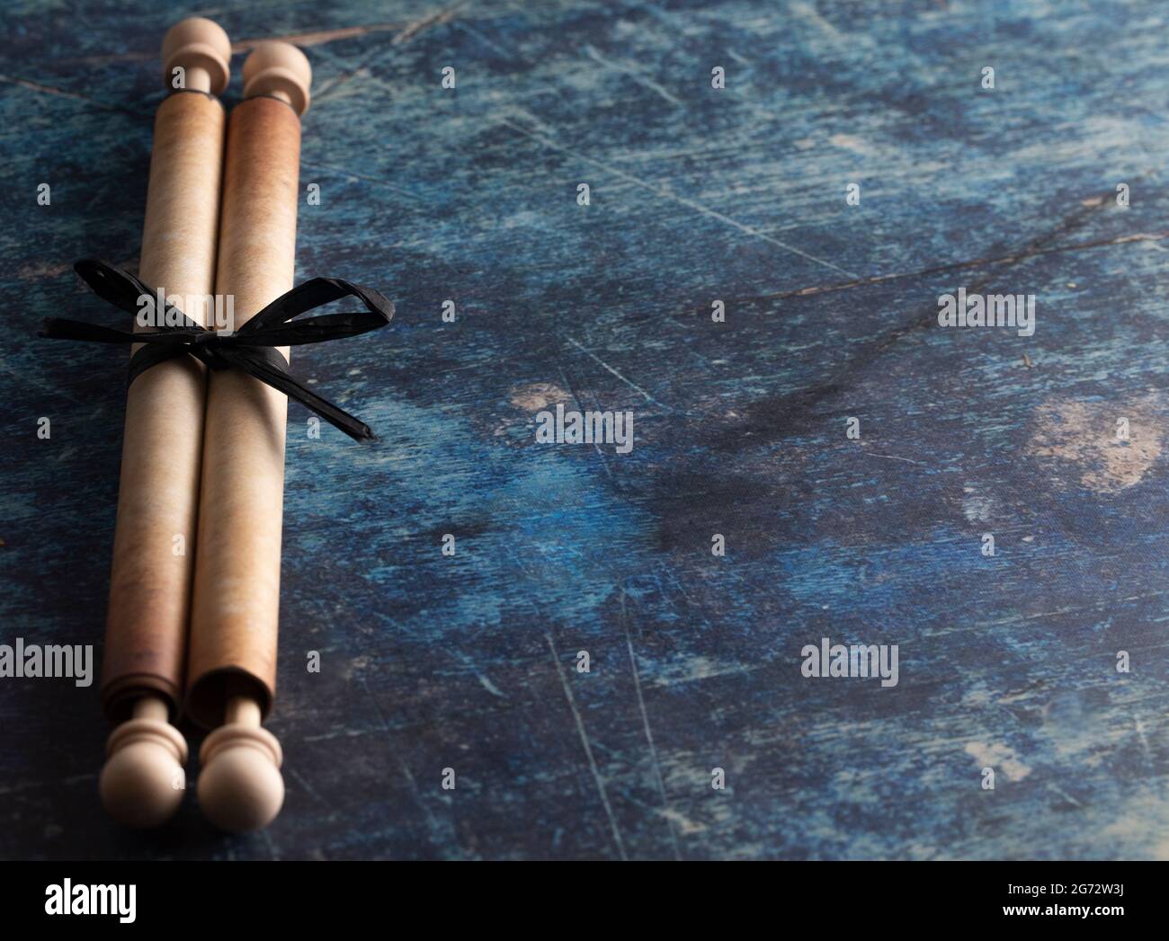 Closed Antique Scroll on a Rustic Blue Wooden Table Stock Photo - Alamy