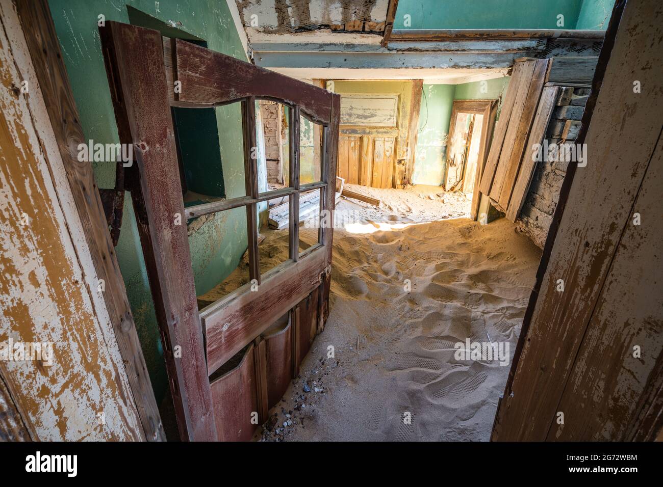 Abandoned building being taken over by encroaching sand in the old ...