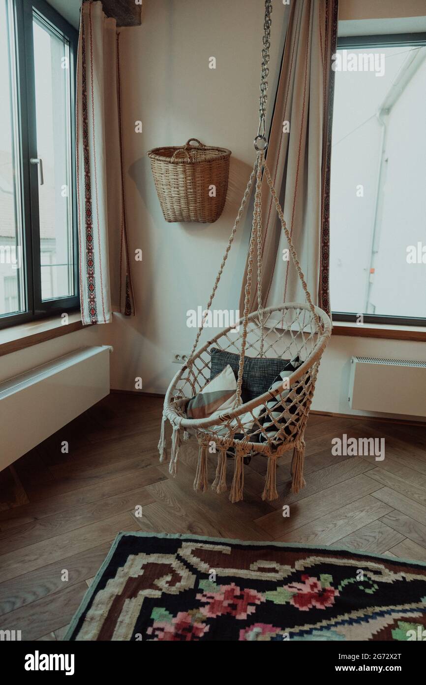 Vertical shot of a macrame hanging chair in a loft-style room Stock ...