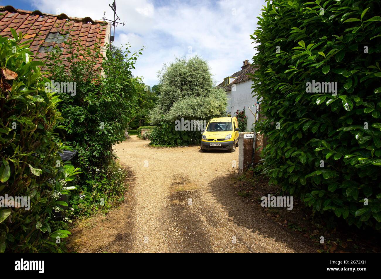 Small yellow van parked on a driveway Stock Photo - Alamy