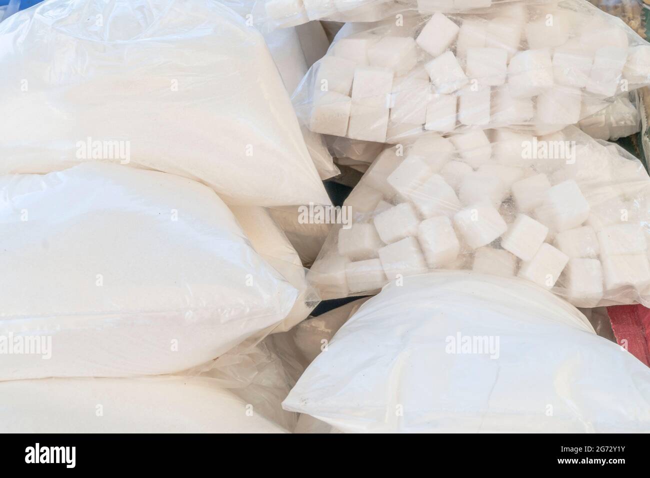 stack of cube and granulated sugar in transparent bags at market Stock ...