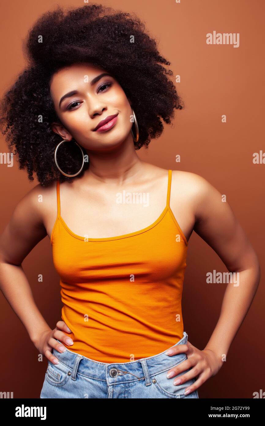 pretty young african american woman with curly hair posing cheerful ...
