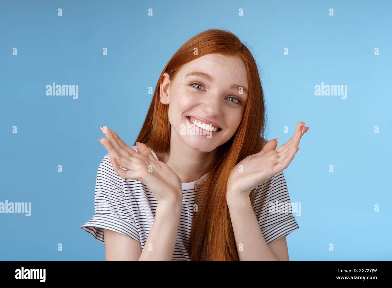 Silly cute sincere young european ginger girl blue eyes shrugging hold ...