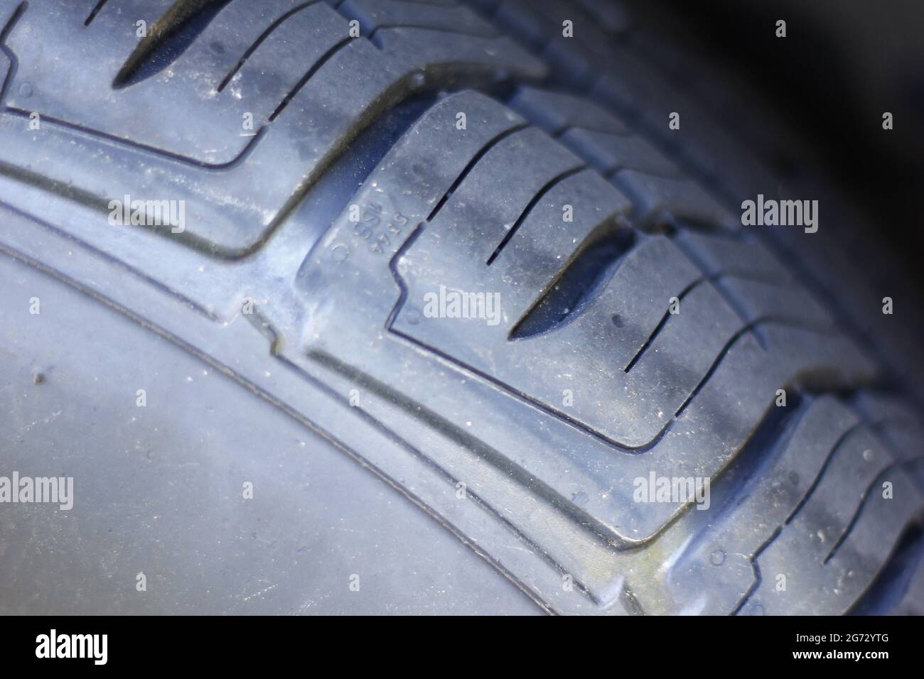 Closeup of patterns on the car tire. Horizontal shot. Black rubber tire ...