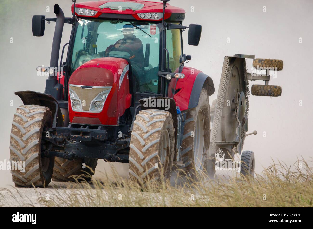 McCormick X6.4 VT large red tractor throwing up clouds of dust as it ...