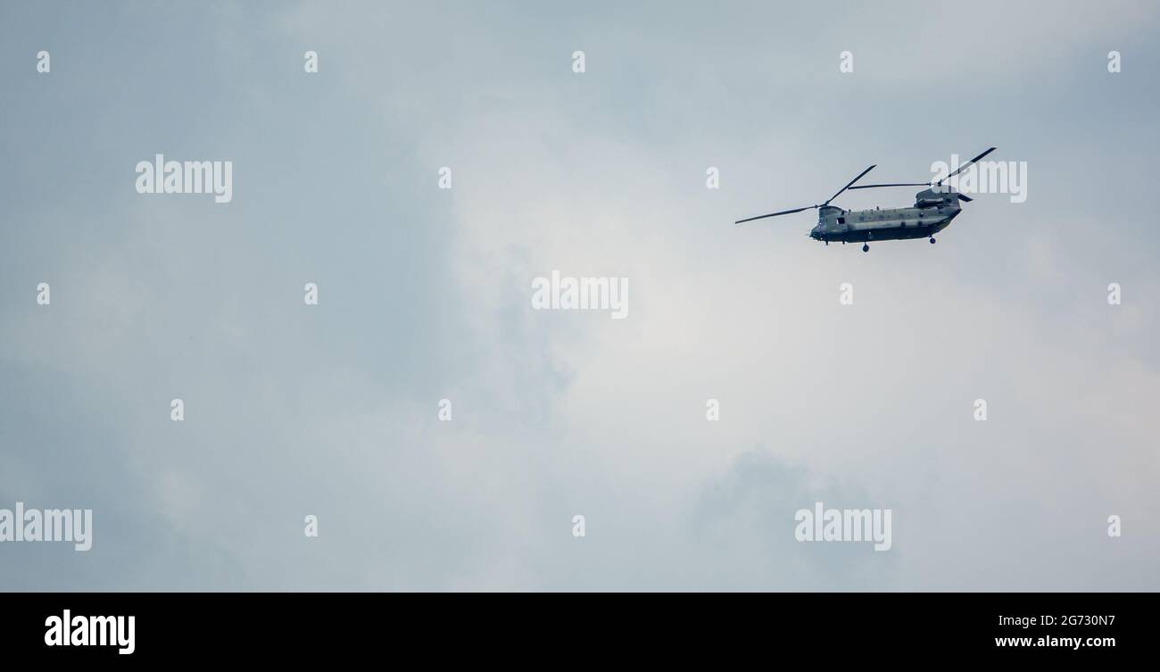 RAF Chinook tandem-rotor CH-47 helicopter flying fast and low in a ...