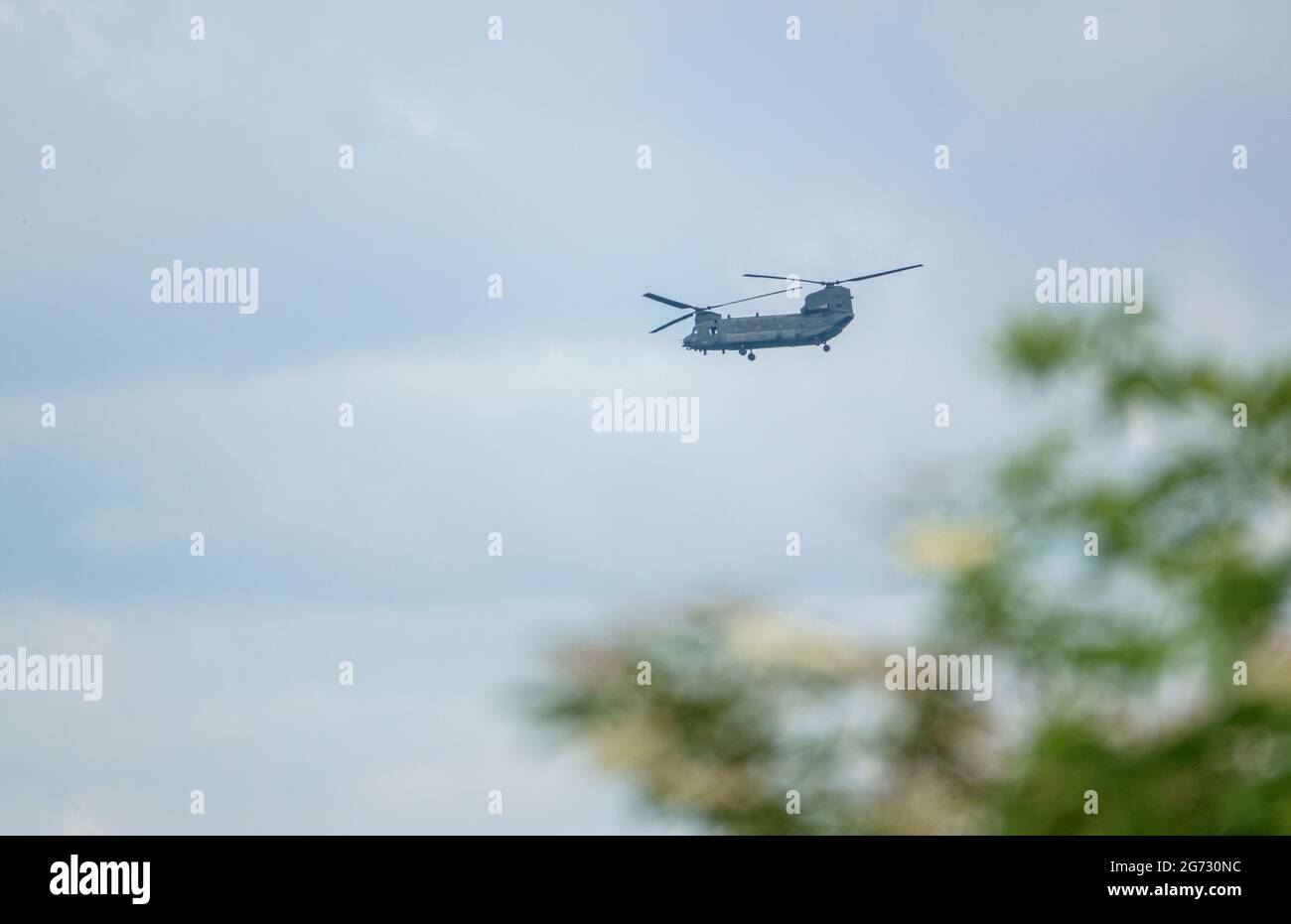 RAF Chinook tandem-rotor CH-47 helicopter flying fast and low in a ...