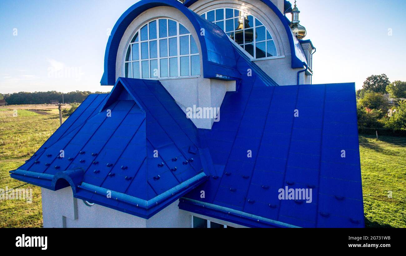 Blue tile and a beautiful arched window on the new church Stock Photo ...