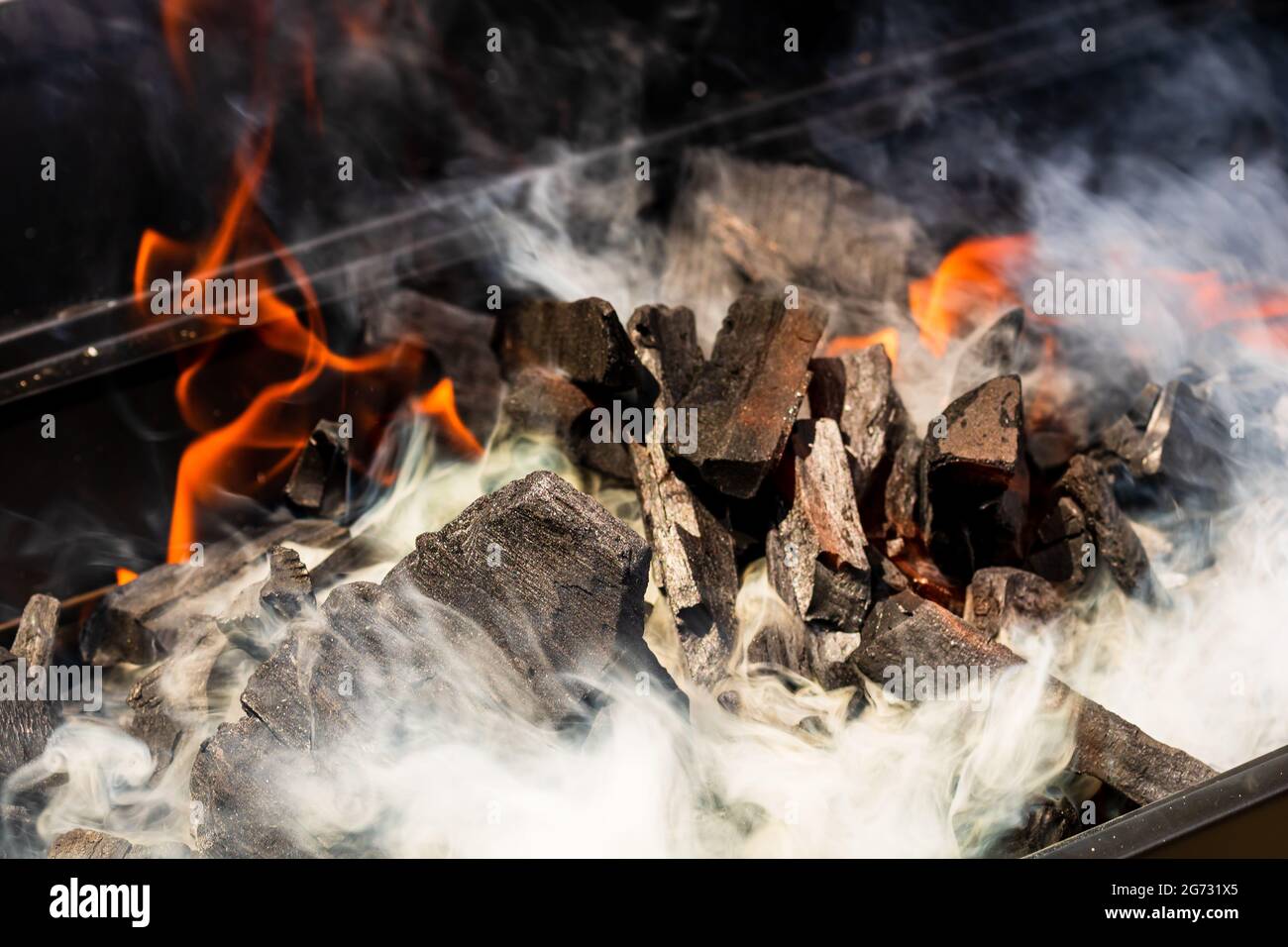 Barbecue grill pit with glowing and flaming hot open fire with red ...