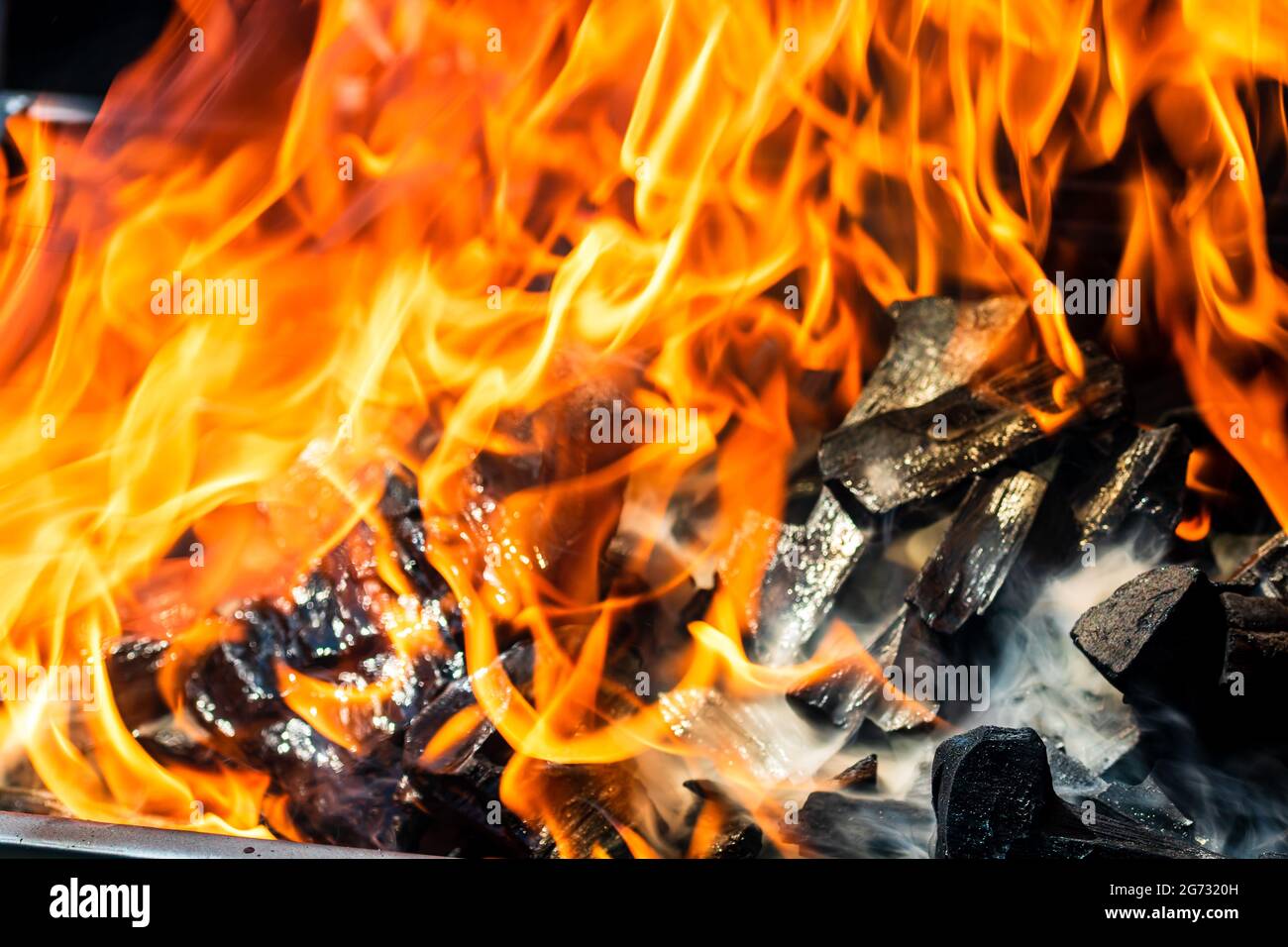 Barbecue grill pit with glowing and flaming hot open fire with red ...