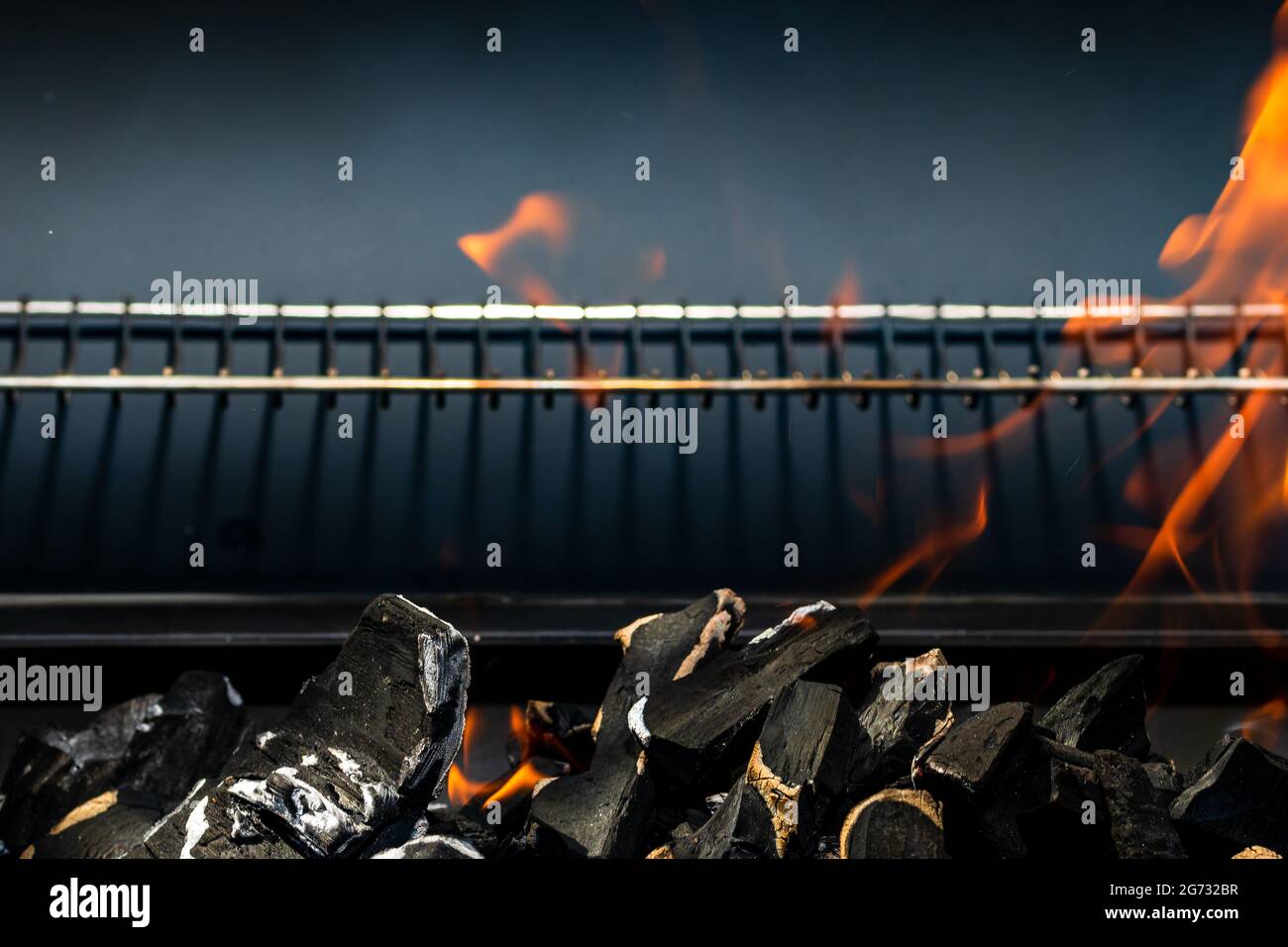 Barbecue grill pit with glowing and flaming hot open fire with red ...