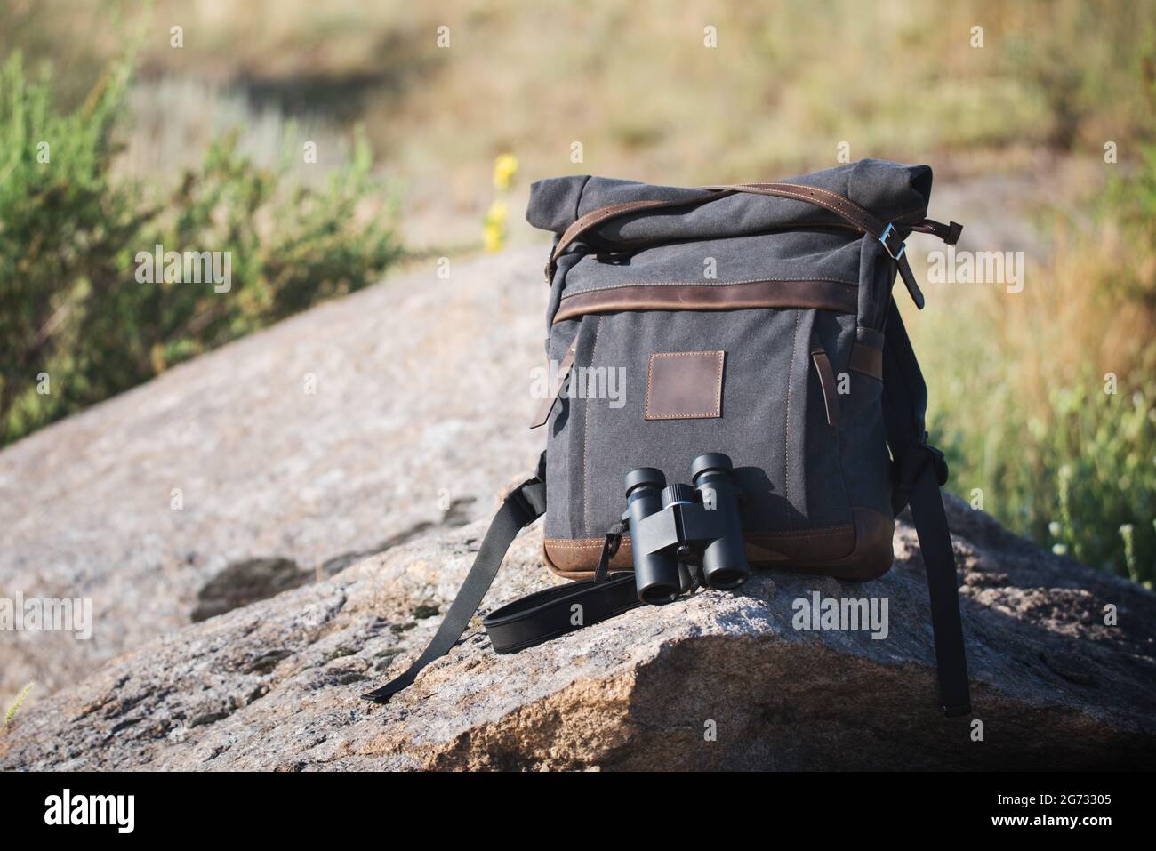 The set for birdwatcher with dark gray backpack and binoculars for ...