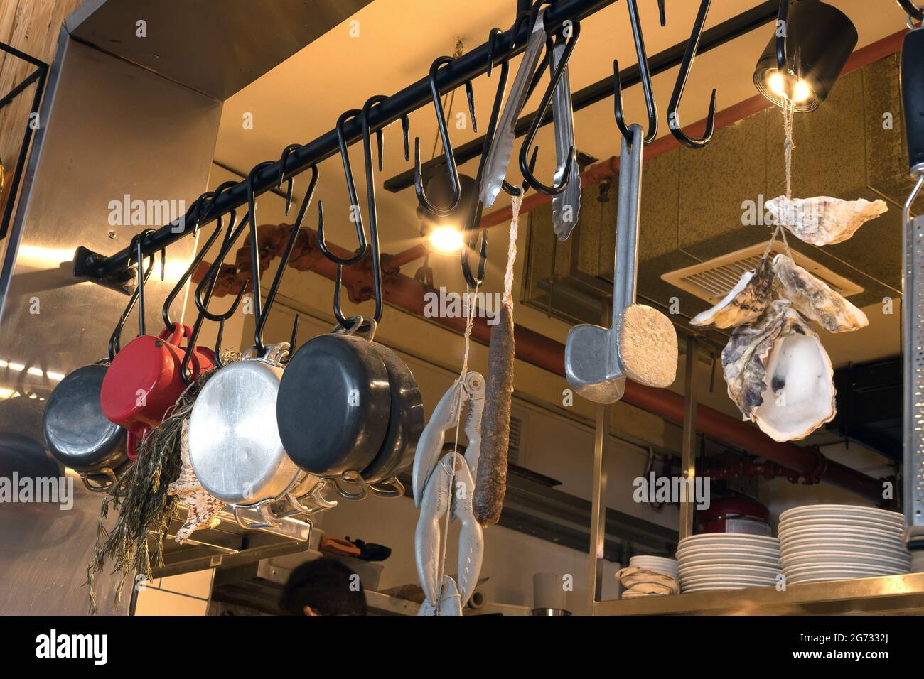 kitchen utensils hung on hooks in the kitchen Stock Photo - Alamy