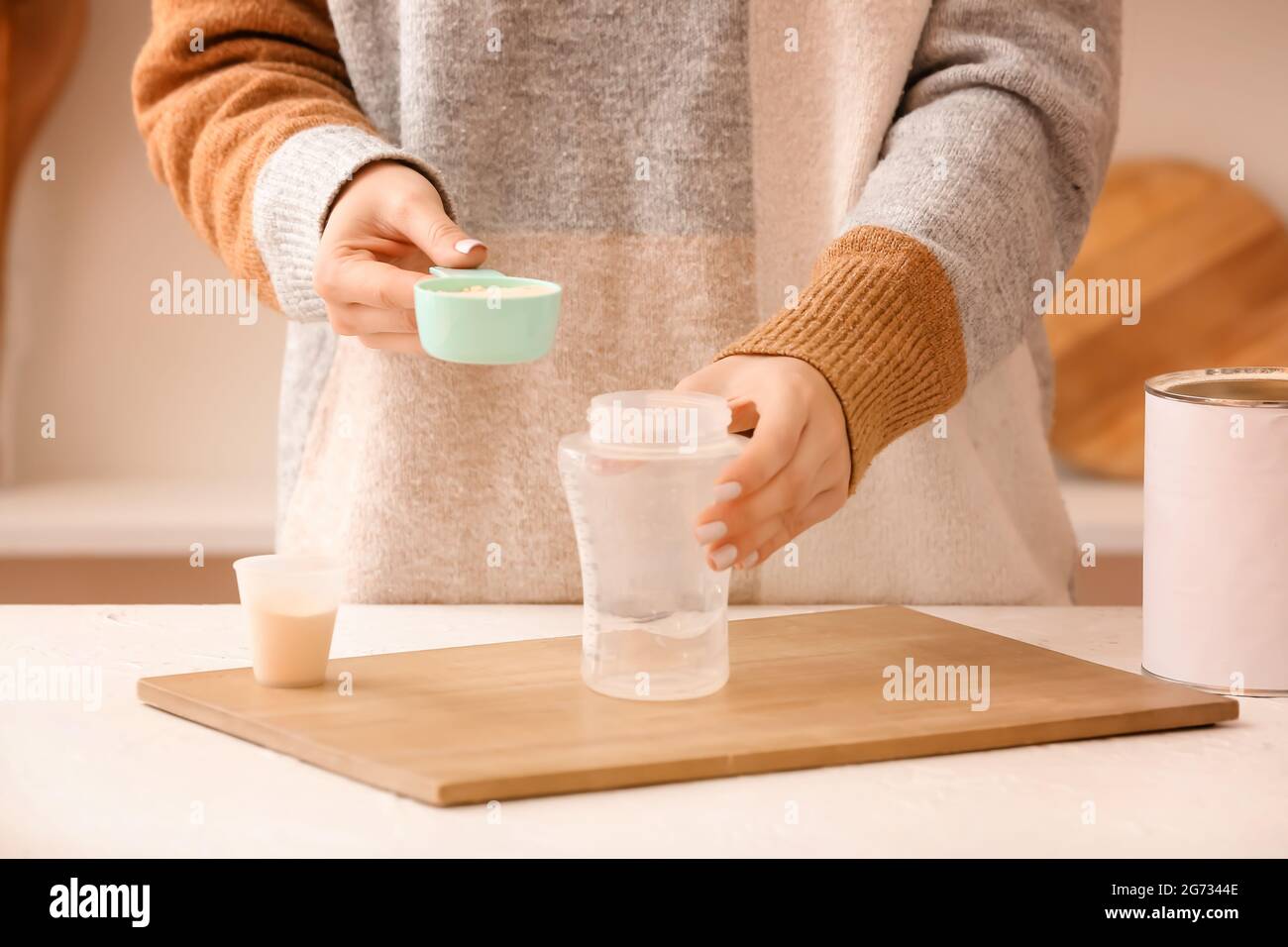 Woman preparing baby formula hi-res stock photography and images - Alamy
