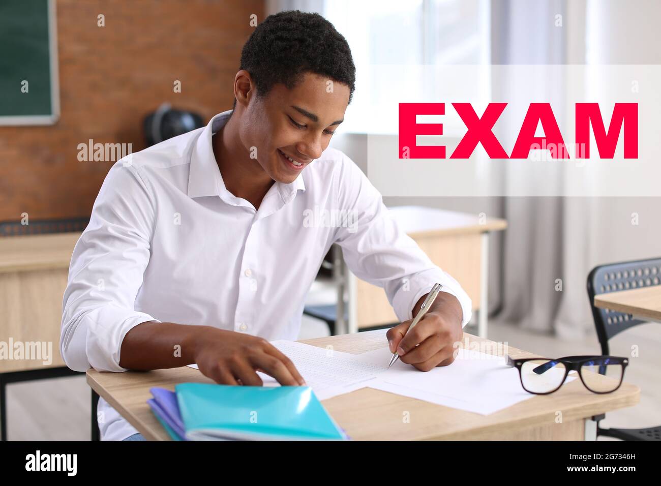 African-American student passing exam at school Stock Photo - Alamy