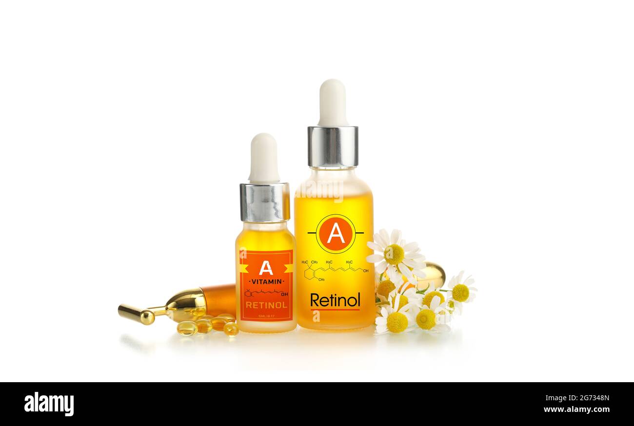 Bottles of vitamin A oil and pills on white background Stock Photo - Alamy