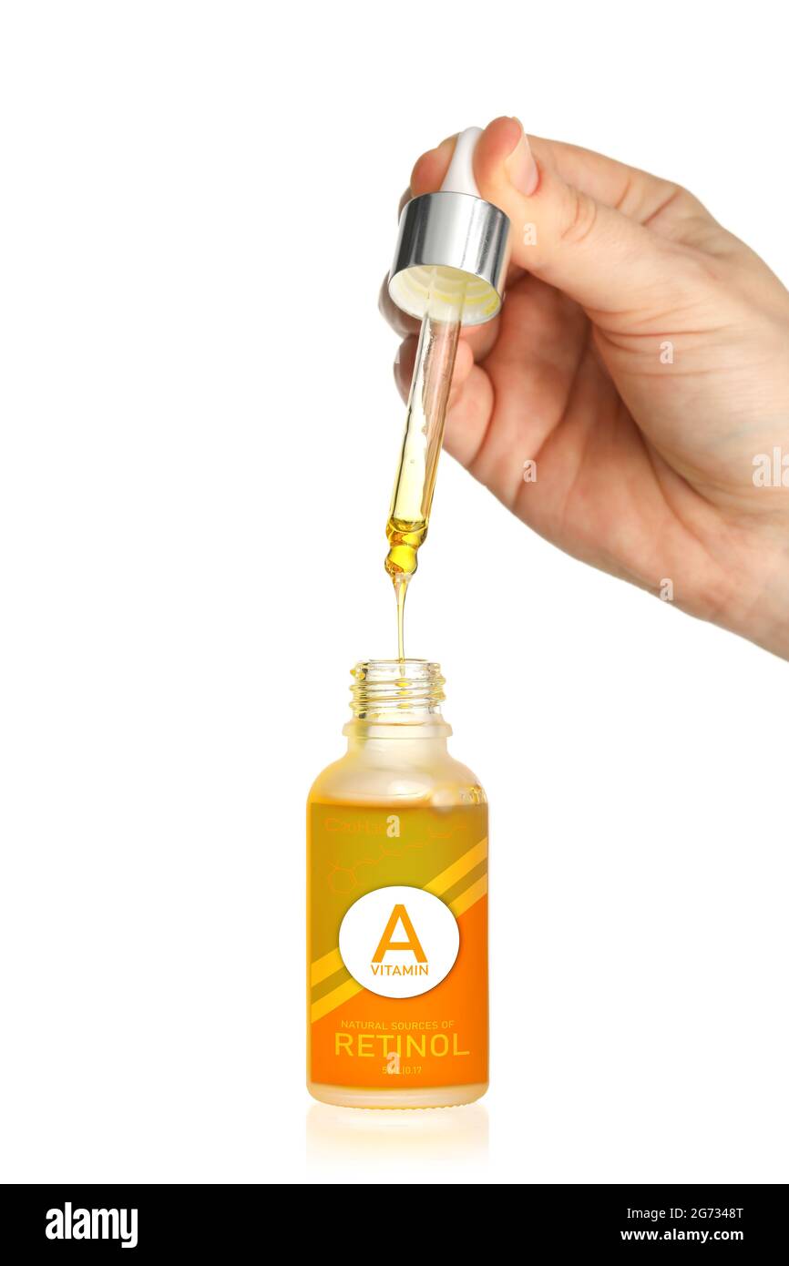 Female hand with bottle of vitamin A oil on white background Stock ...