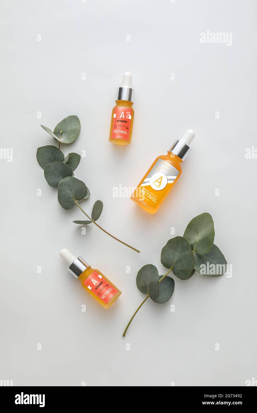 Bottles of vitamin A oil on grey background Stock Photo - Alamy