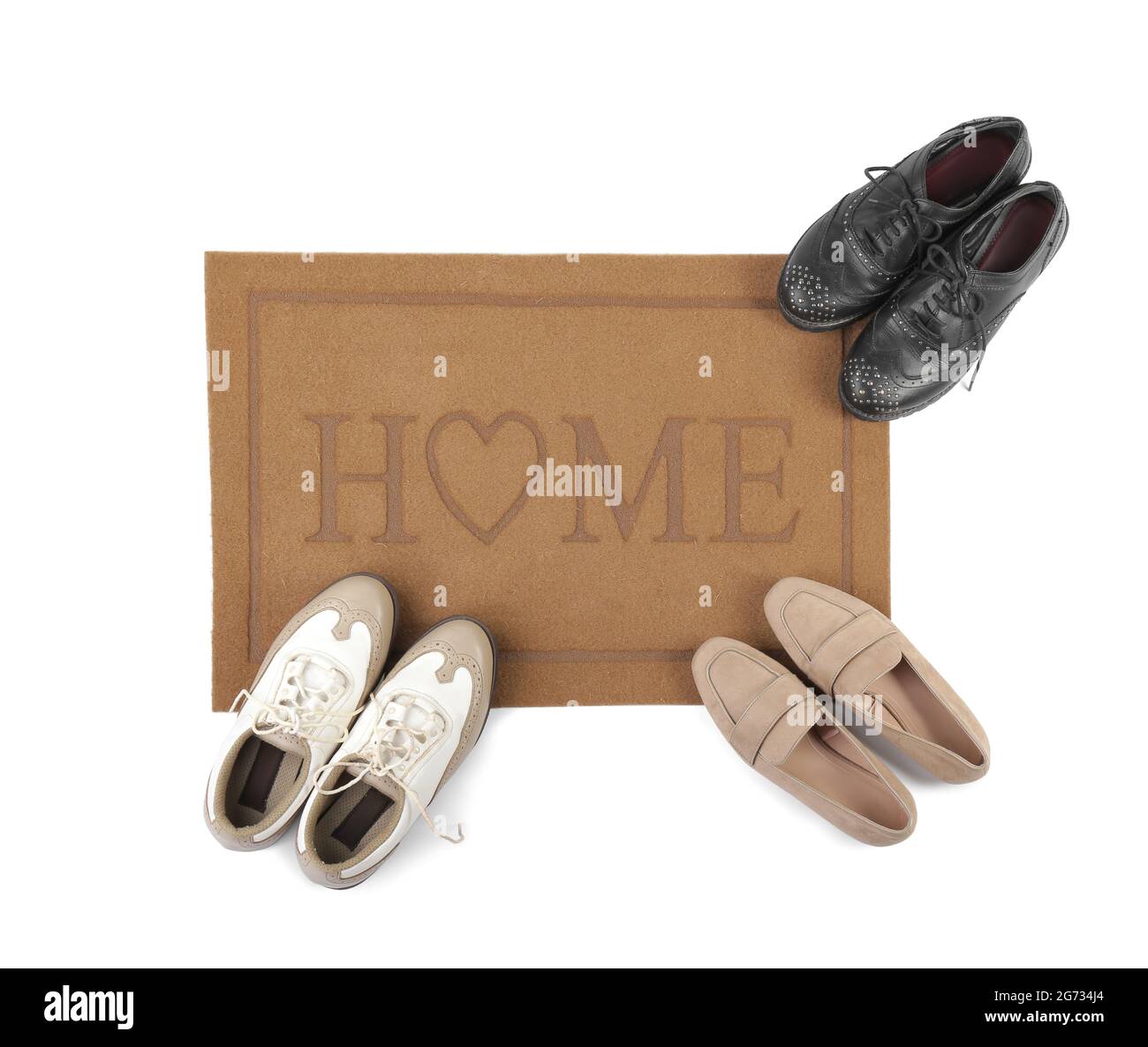 Doormat with shoes on white background Stock Photo - Alamy