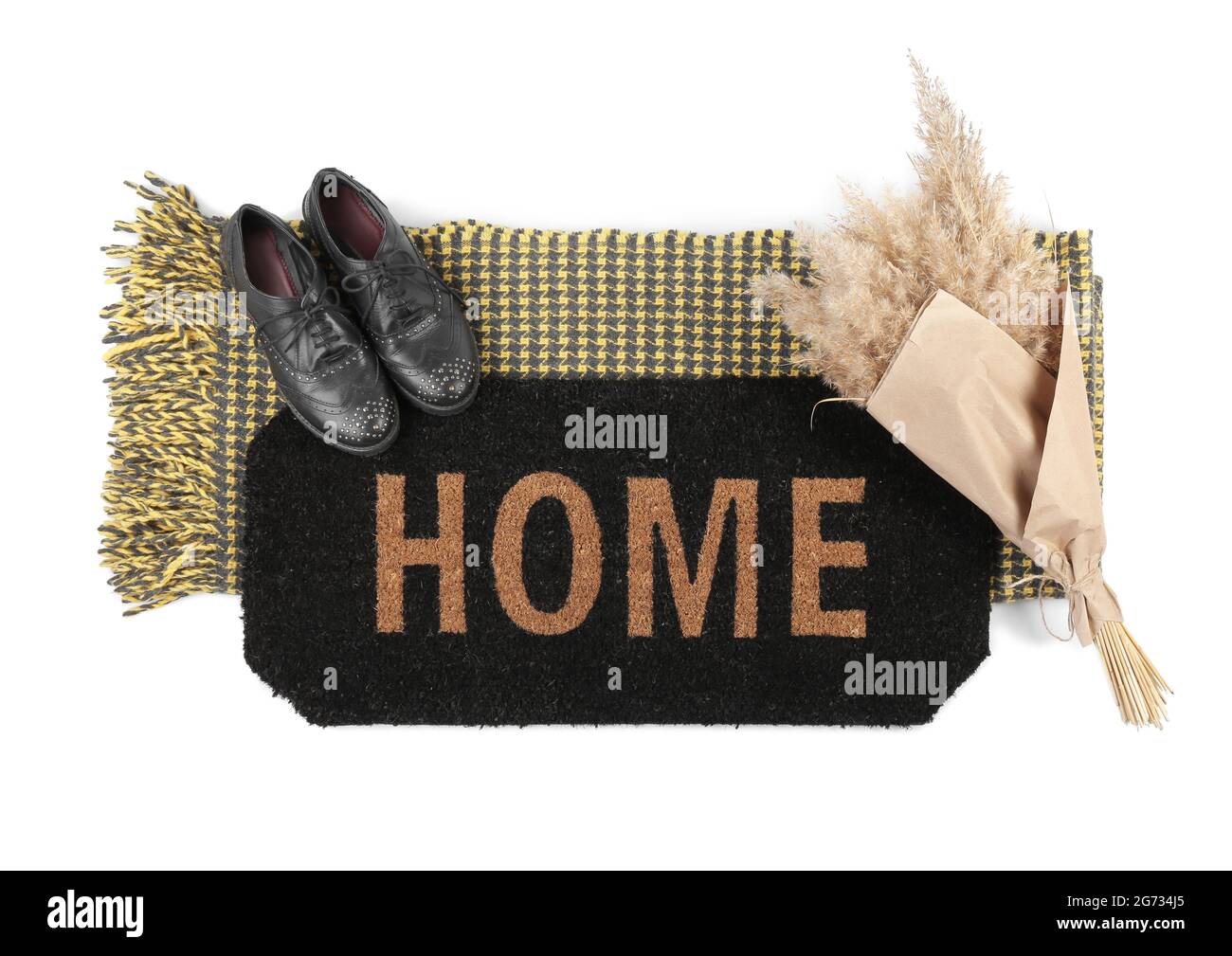 Doormat with shoes and plaid on white background Stock Photo - Alamy