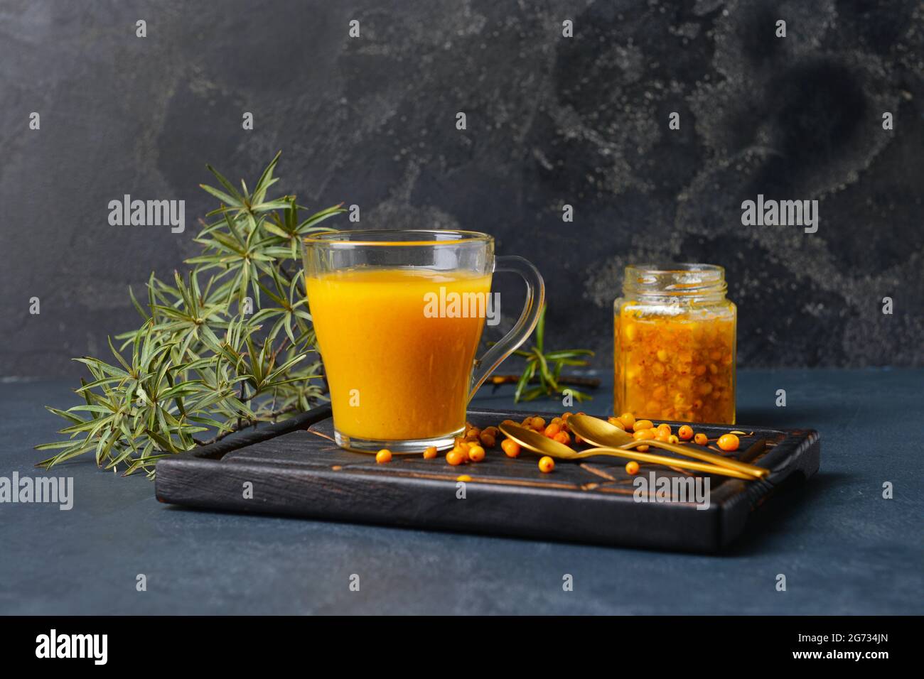 Cup of healthy sea buckthorn tea on dark background Stock Photo - Alamy