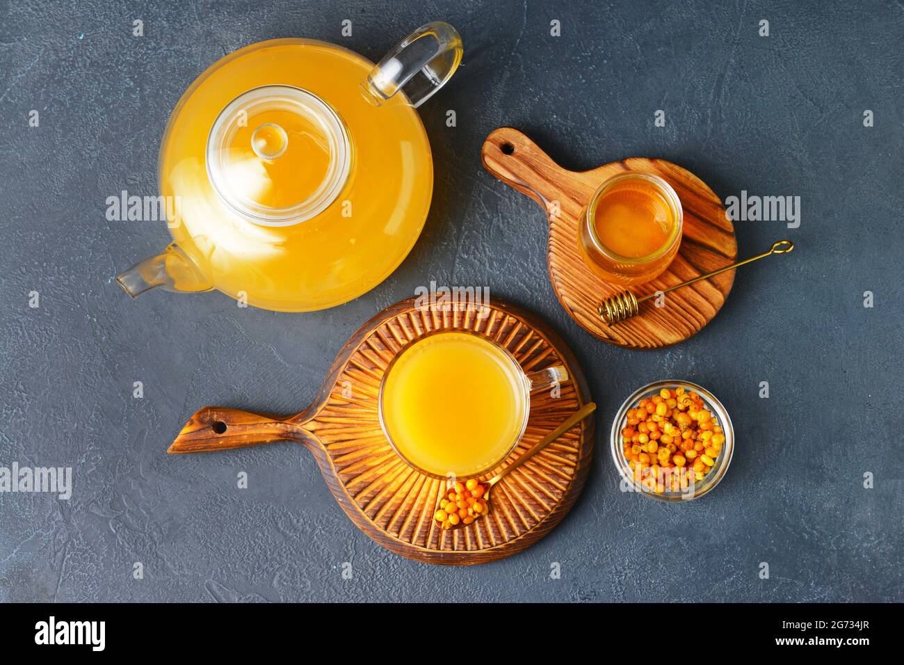 Healthy sea buckthorn tea with honey on dark background Stock Photo - Alamy