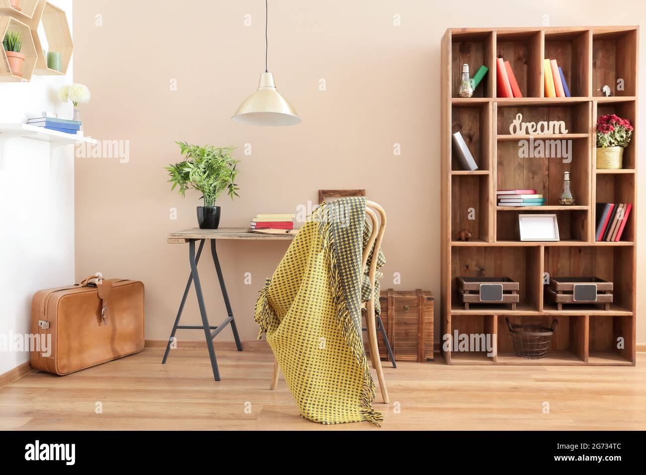 Interior of modern room with shelf unit and table Stock Photo - Alamy