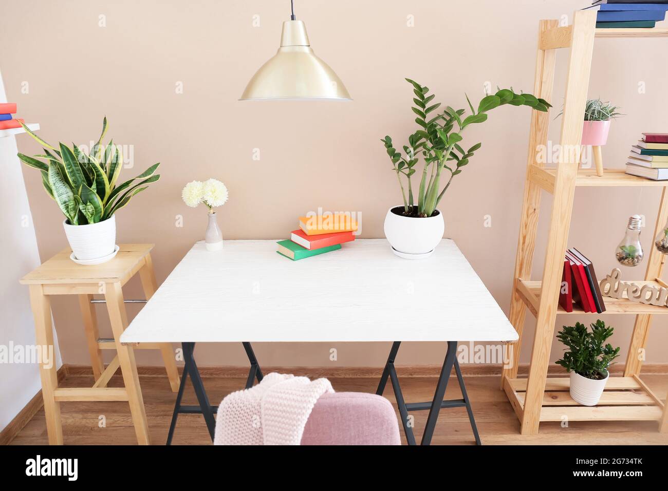 Interior of modern room with shelf unit and table Stock Photo - Alamy
