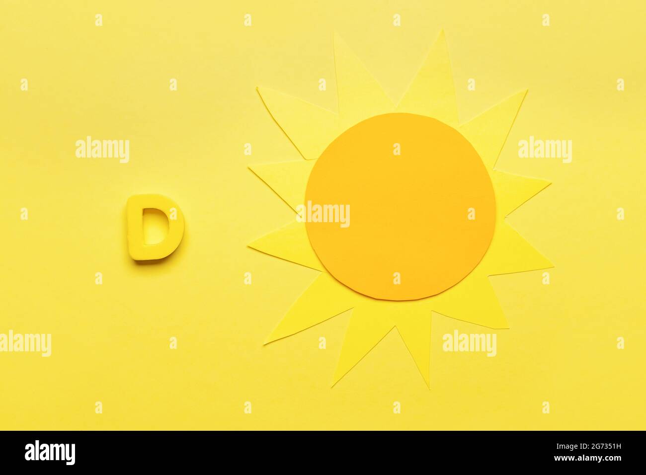Letter D with sun on color background Stock Photo - Alamy