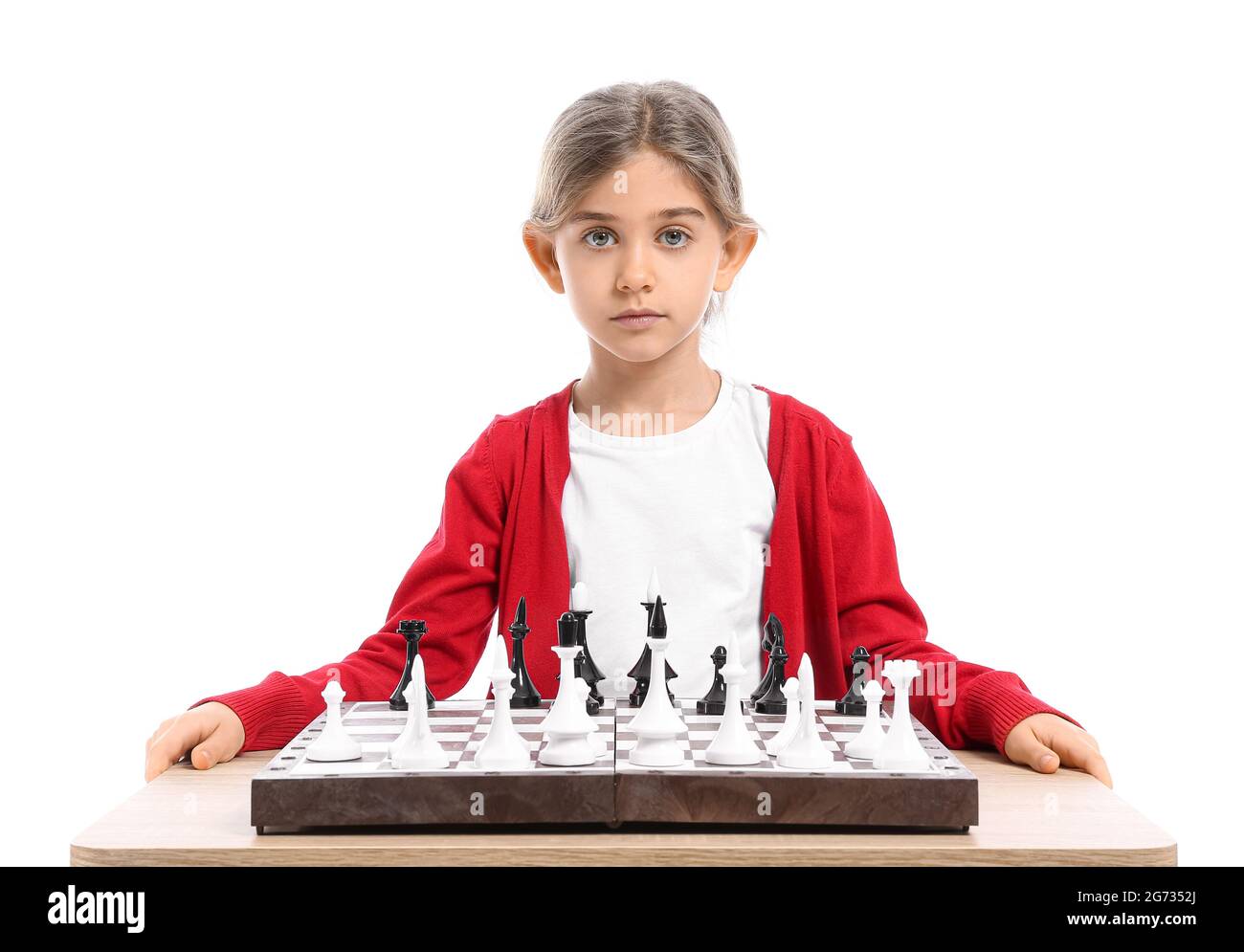 Cute little girl playing chess on white background Stock Photo - Alamy