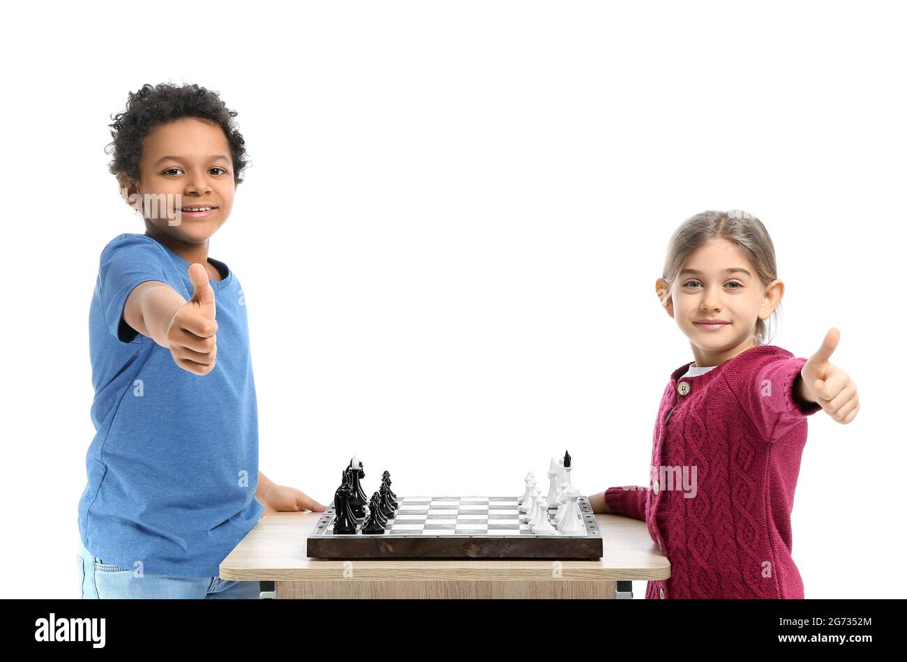 Cute little children playing chess on white background Stock Photo - Alamy