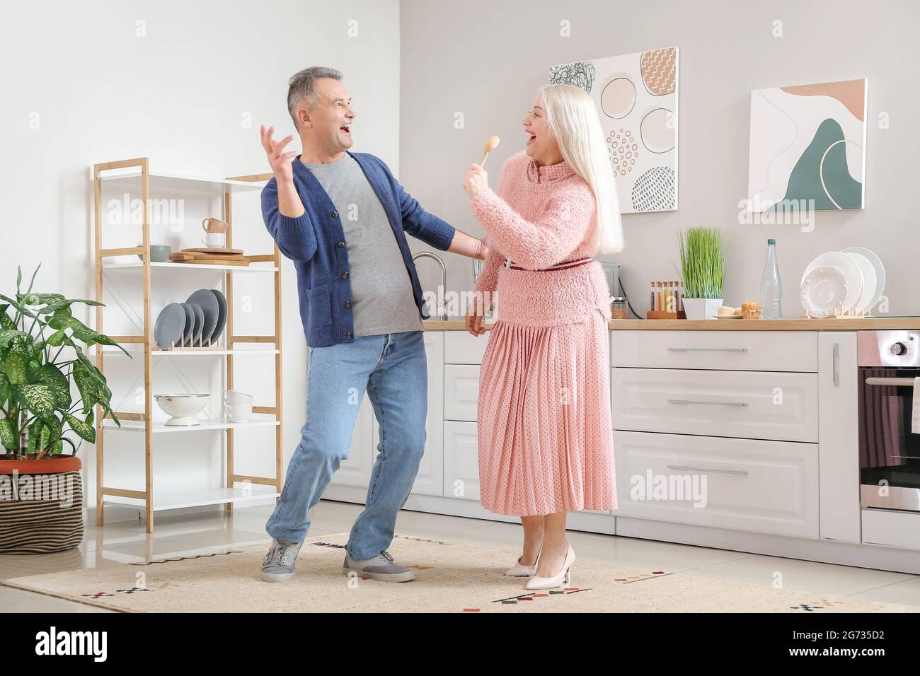 Happy mature couple dancing at home Stock Photo - Alamy